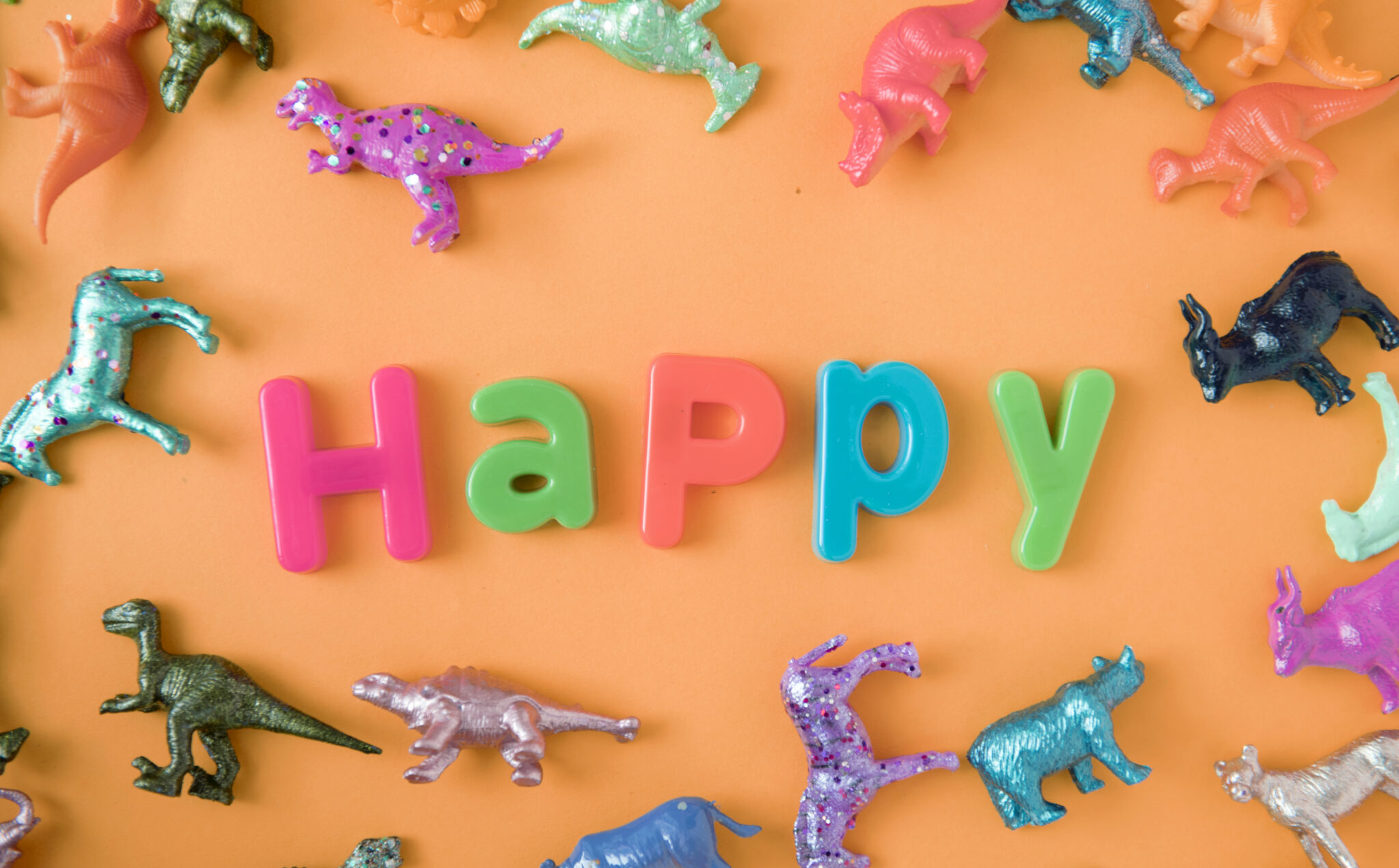 Various animal toy figures background with the word happy - Six Clever ...