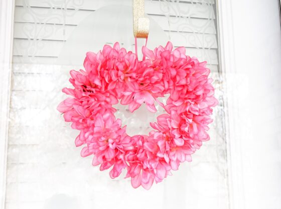 hang-the-pink-flower-heart-wreath-diy-on-a-door - Six Clever Sisters